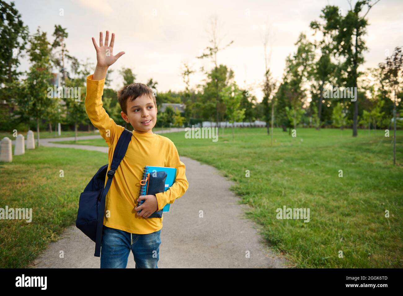 A charming handsome friendly schoolboy 9 years old in the park, with a ...