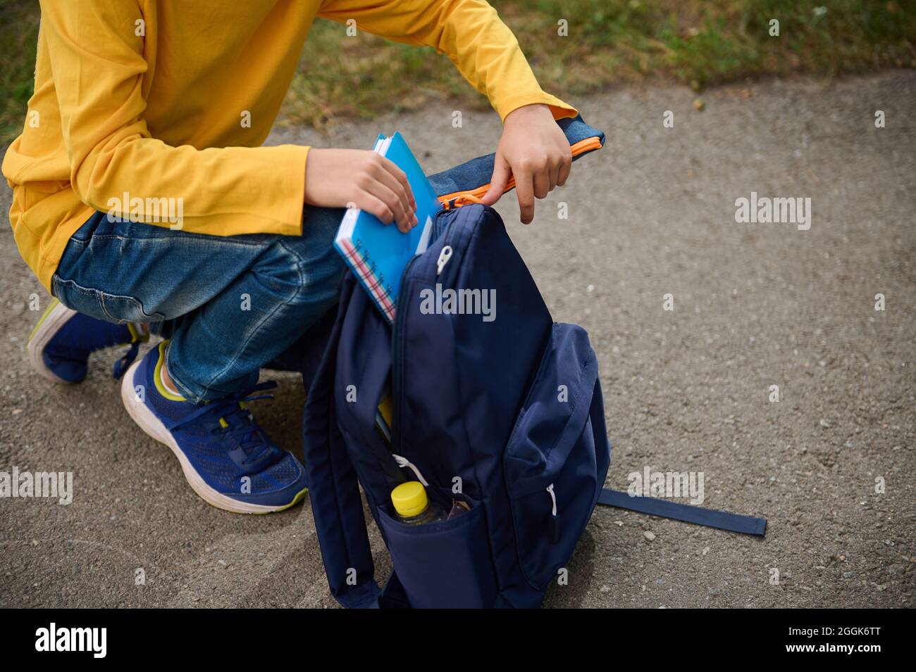 Close-up, cropped view of an unrecognizable schoolboy putting a ...