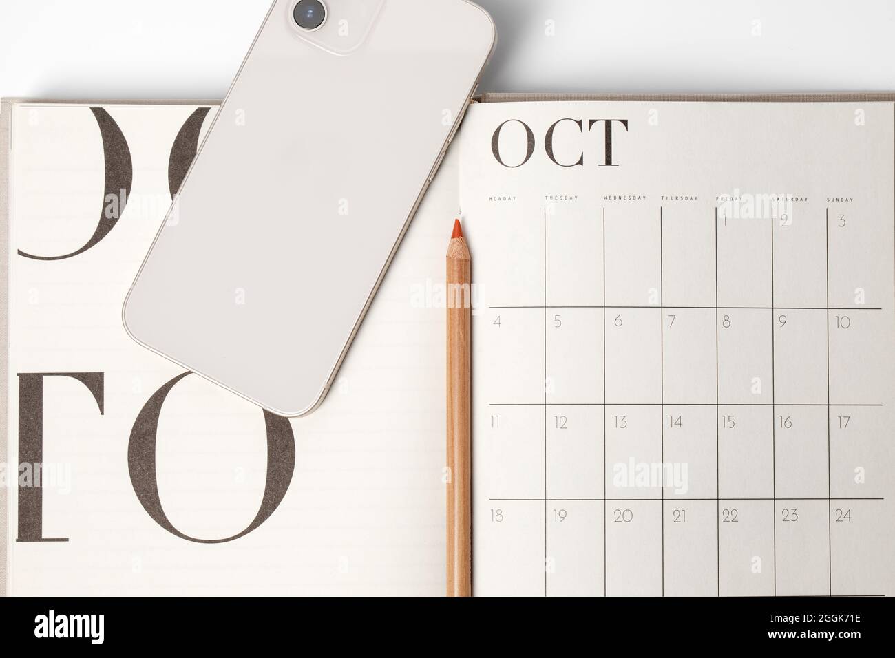 Monthly calendar, red pencil and modern smartphone on white background ...