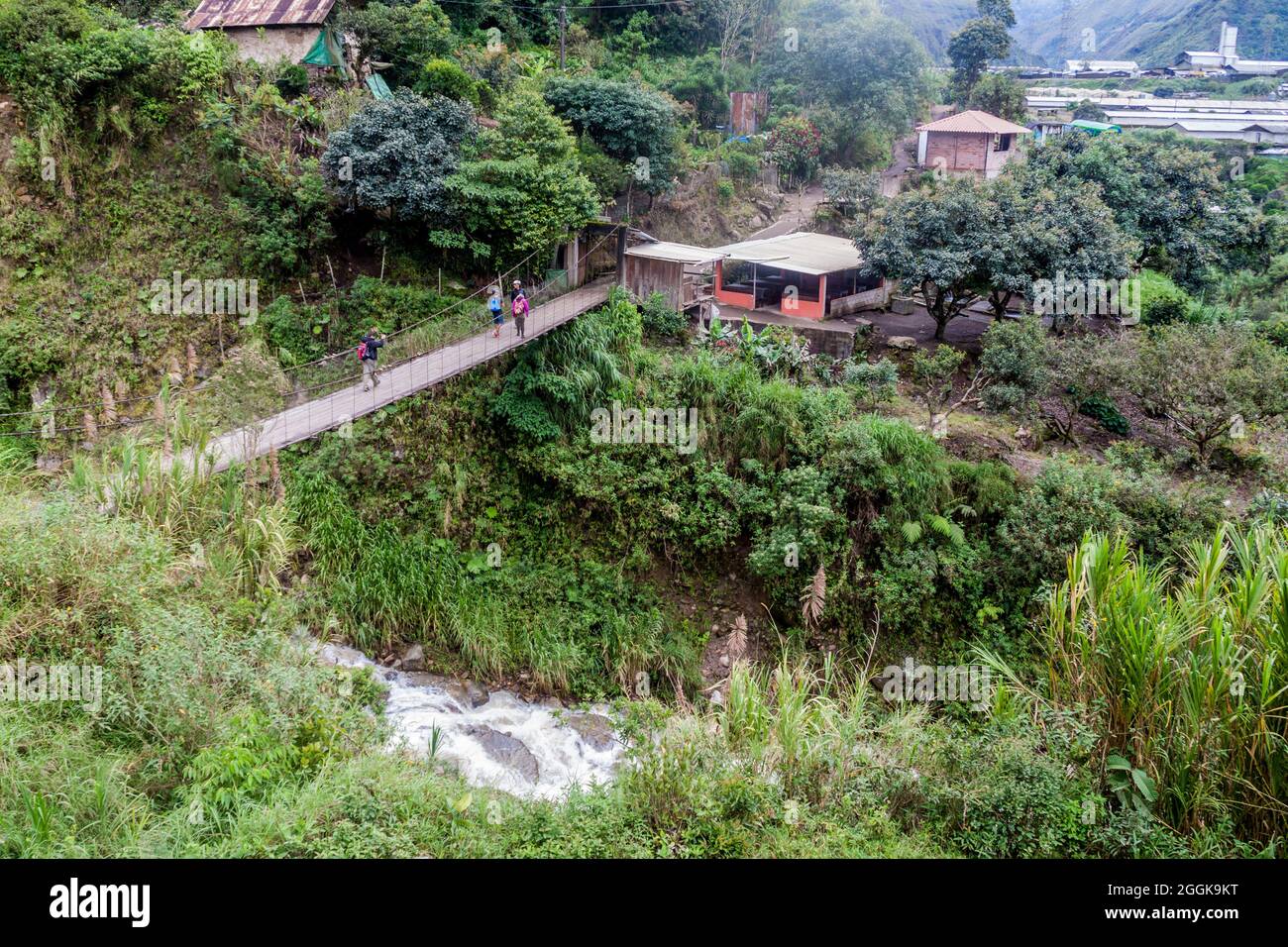 BANOS, ECUADOR - JUNE 22, 2015: Suspension bridge over small stream in ...