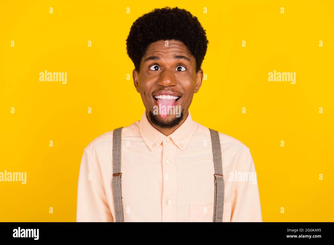 Photo of foolish crazy guy grimace show tongue squint eyes wear ...