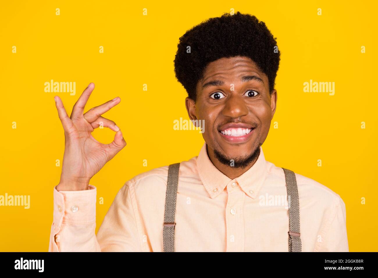 Photo of cheerful glad nice reliable guy show okey sign wear suspenders ...