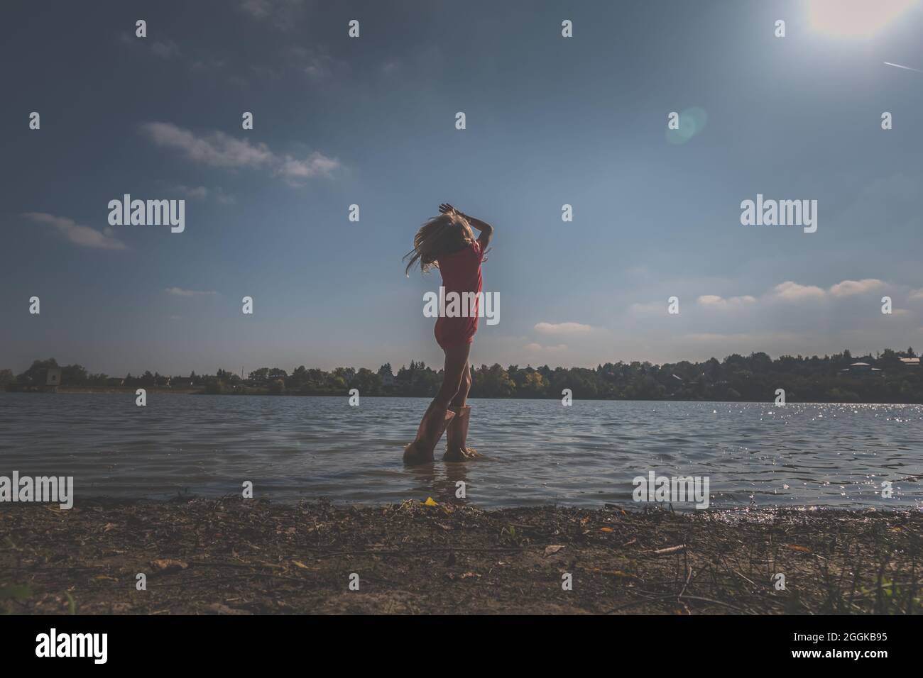 one child splashing water while running in the water Stock Photo - Alamy