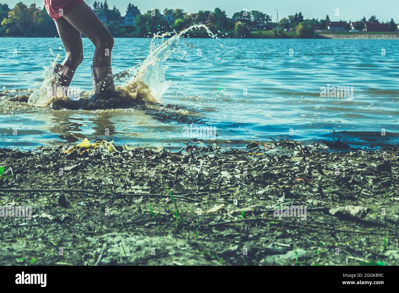 one child splashing water while running in the water Stock Photo - Alamy
