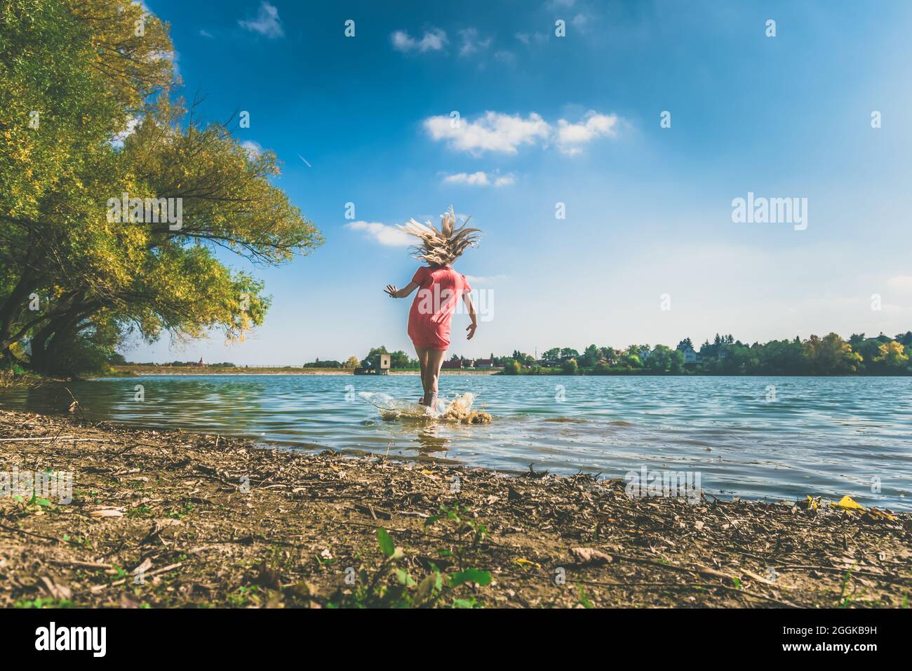 one child splashing water while running in the water, freedom feelings ...