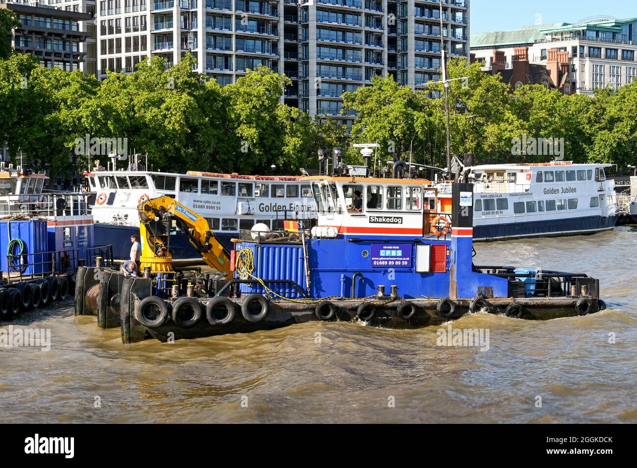 London, England - August 2021: Industrial barge with dredging equipment ...