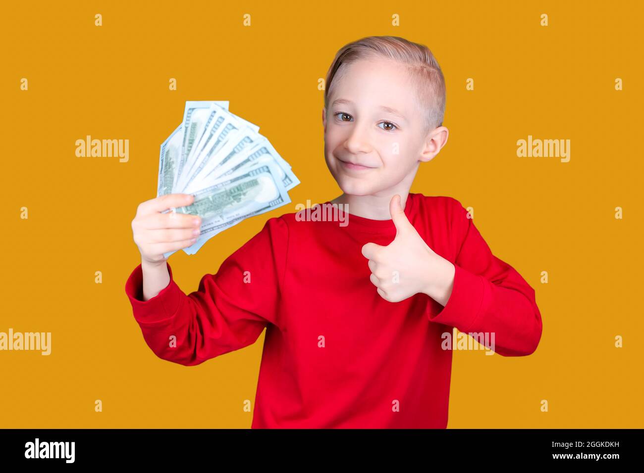 happy child holds banknotes in his hand and gives a thumbs up Stock ...