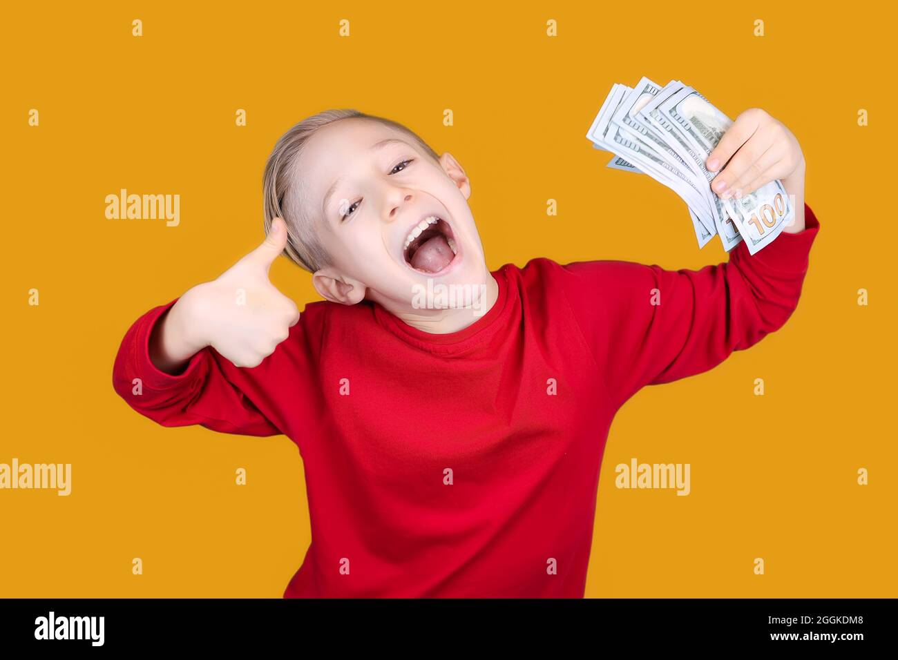 happy child holds banknotes in his hand and gives a thumbs up Stock ...
