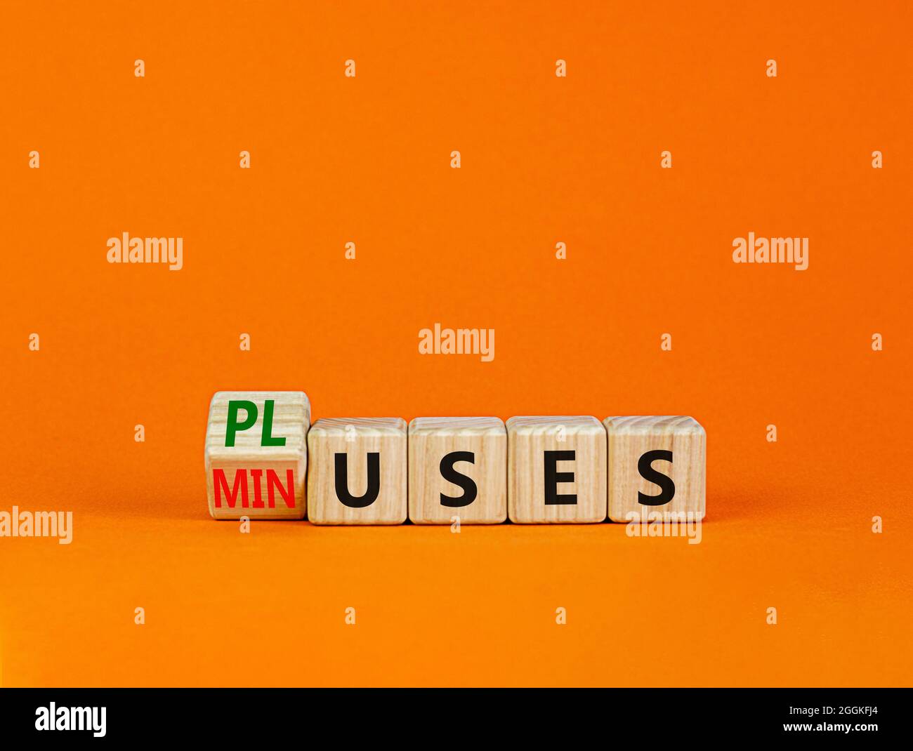 Pluses and minuses symbol. Turned a wooden cube and changed the word ...