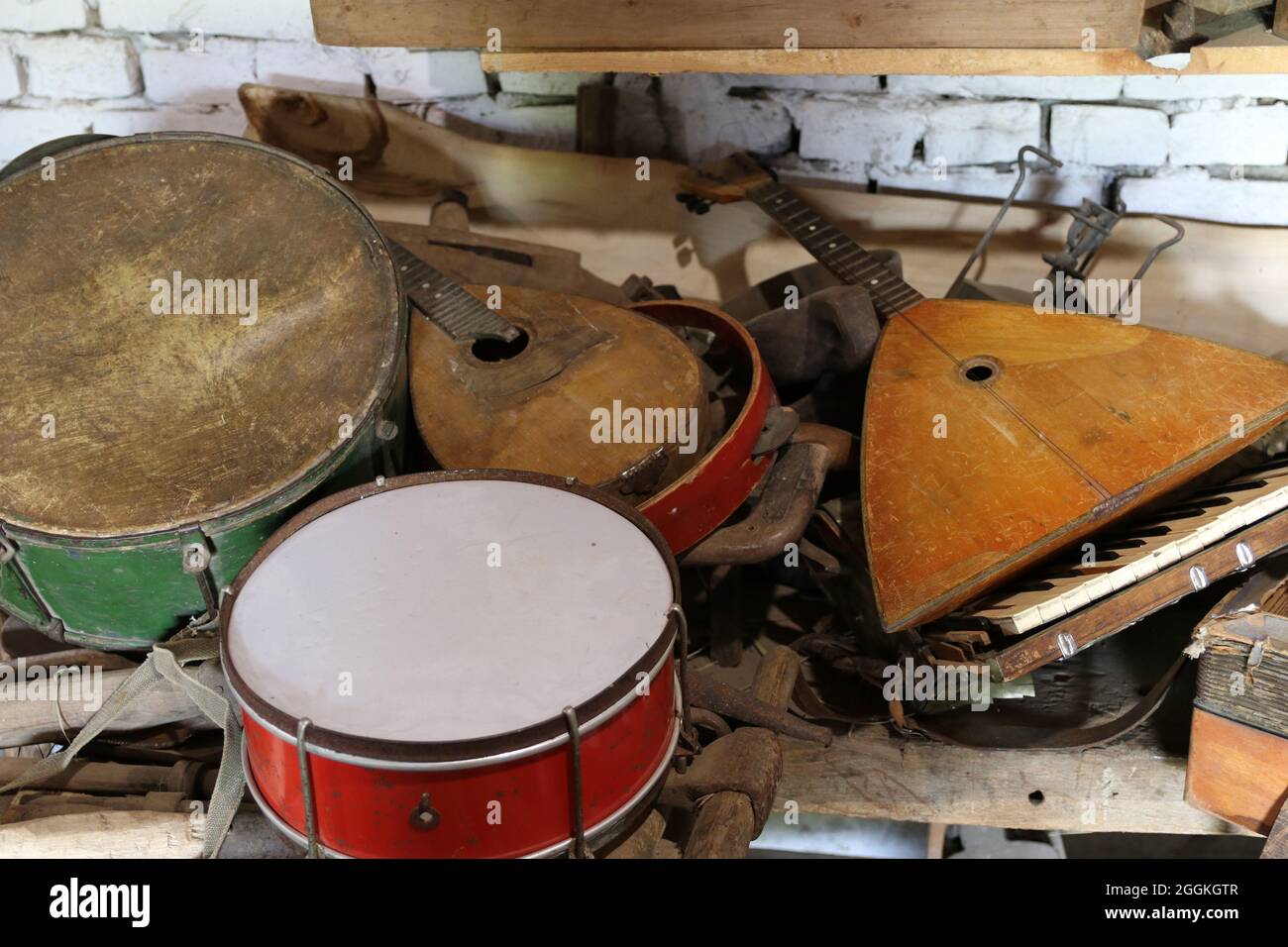 Old broken musical instruments. Drums, guitars and other musical ...