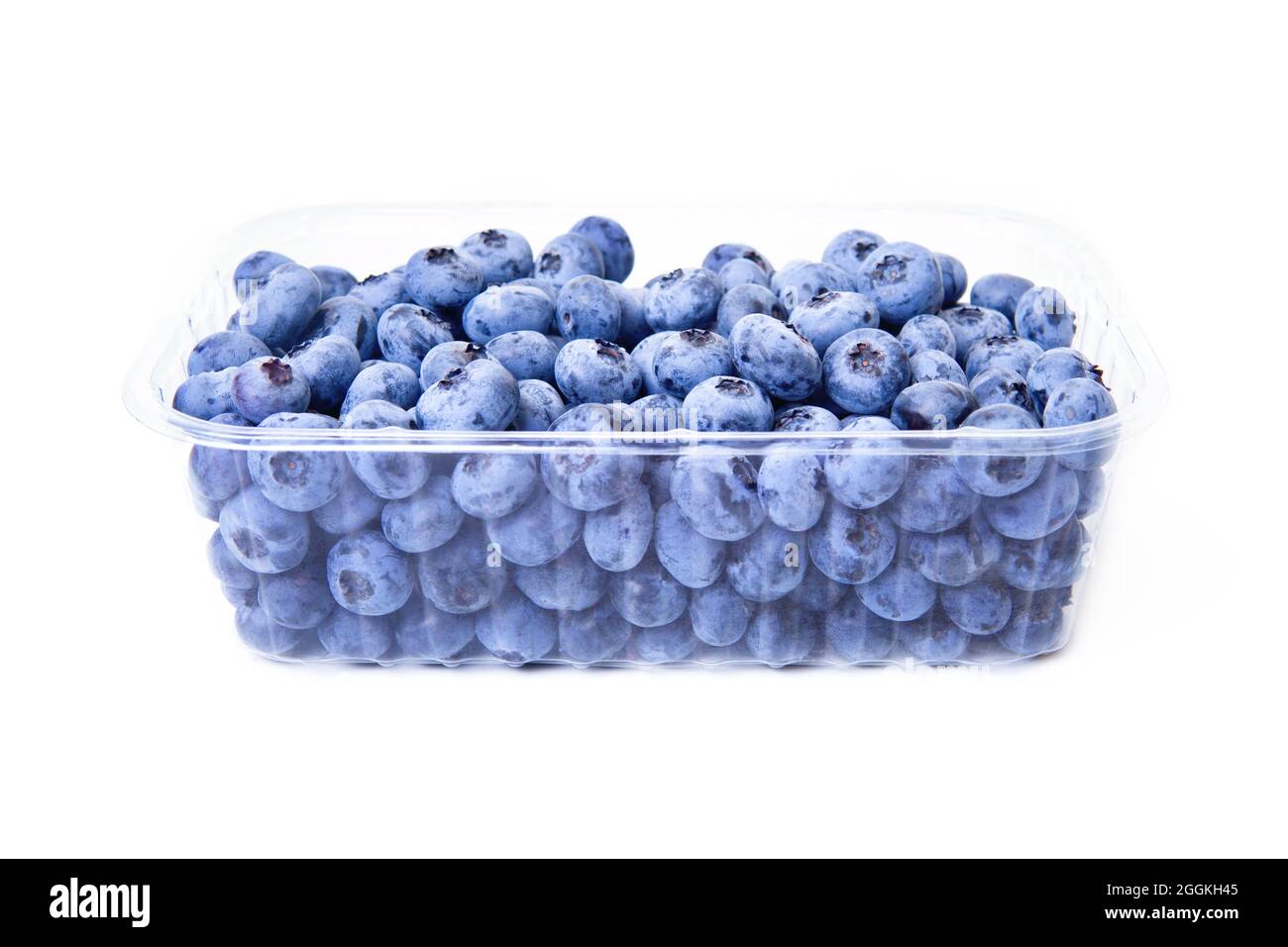 Fresh blueberries in a clear plastic container isolated on white Stock ...