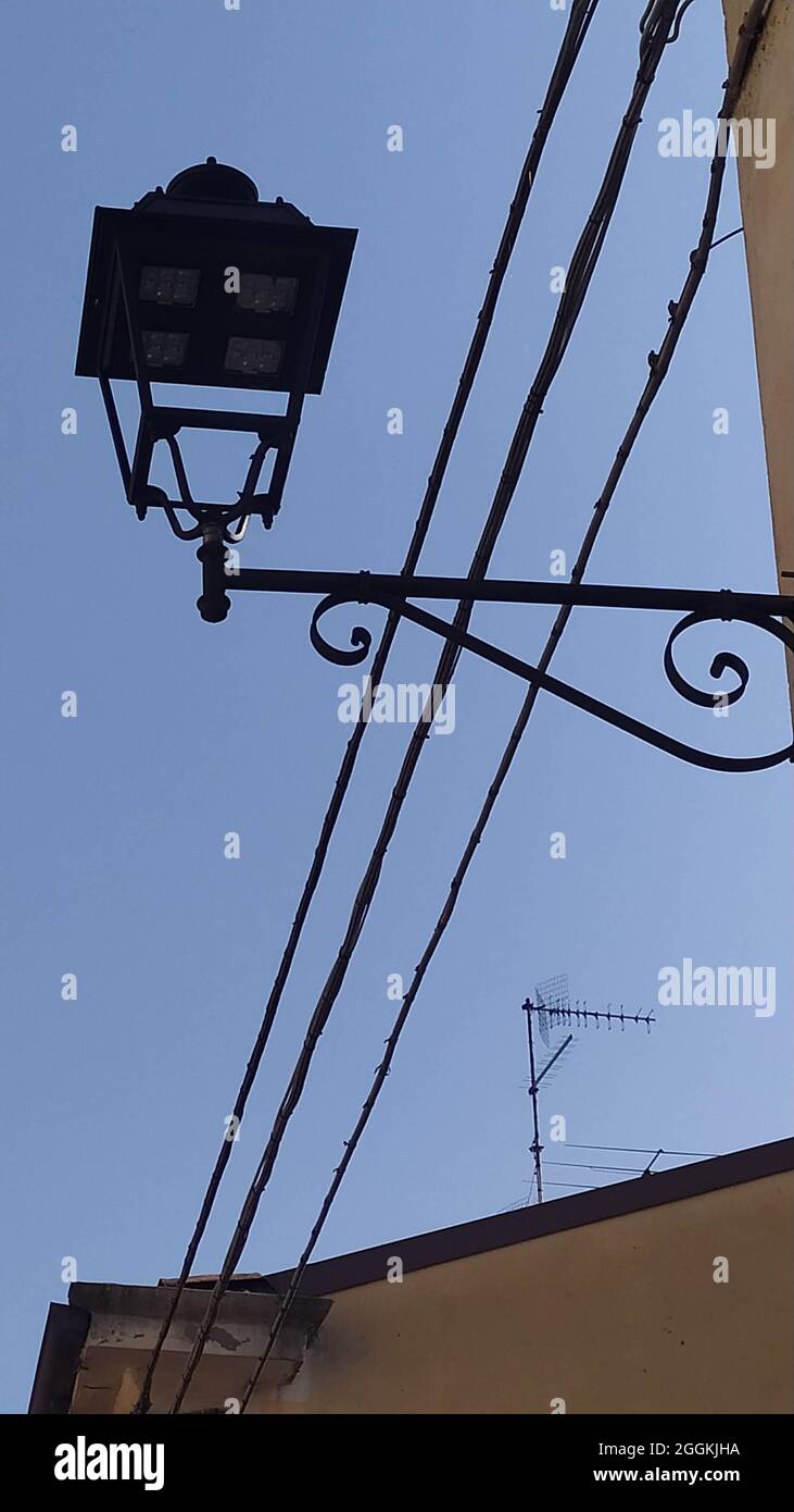Street lamp, electrical cables and antenna of an Italian town. Italy ...
