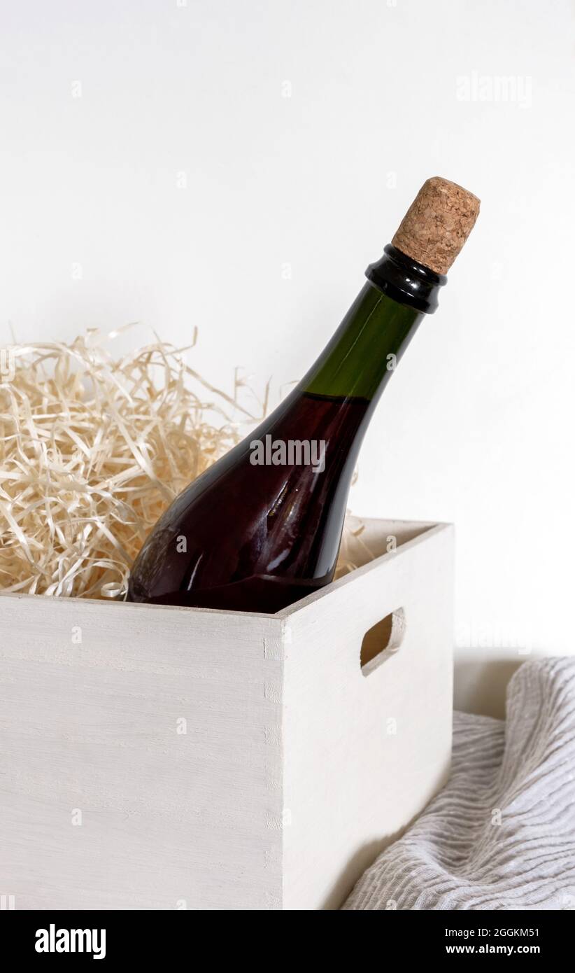 Straw into storage box and bottle of wine on the white background ...