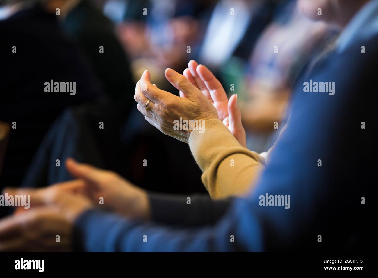 Selective of a female clapping hands Stock Photo - Alamy