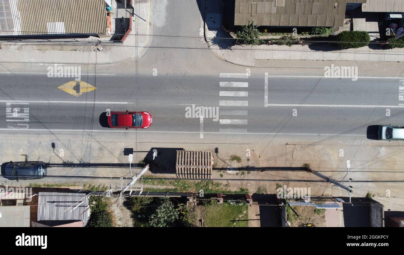 Aerial view of a red car driving on the road in the neighborhood Stock ...