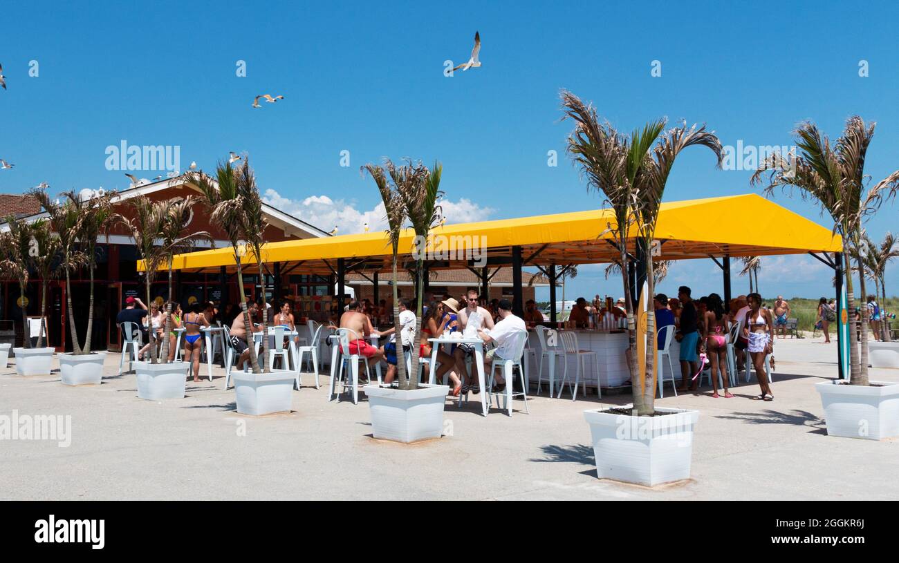Fire Island, NEw York, USA - 24 July 2021: people sitting at a bar ...