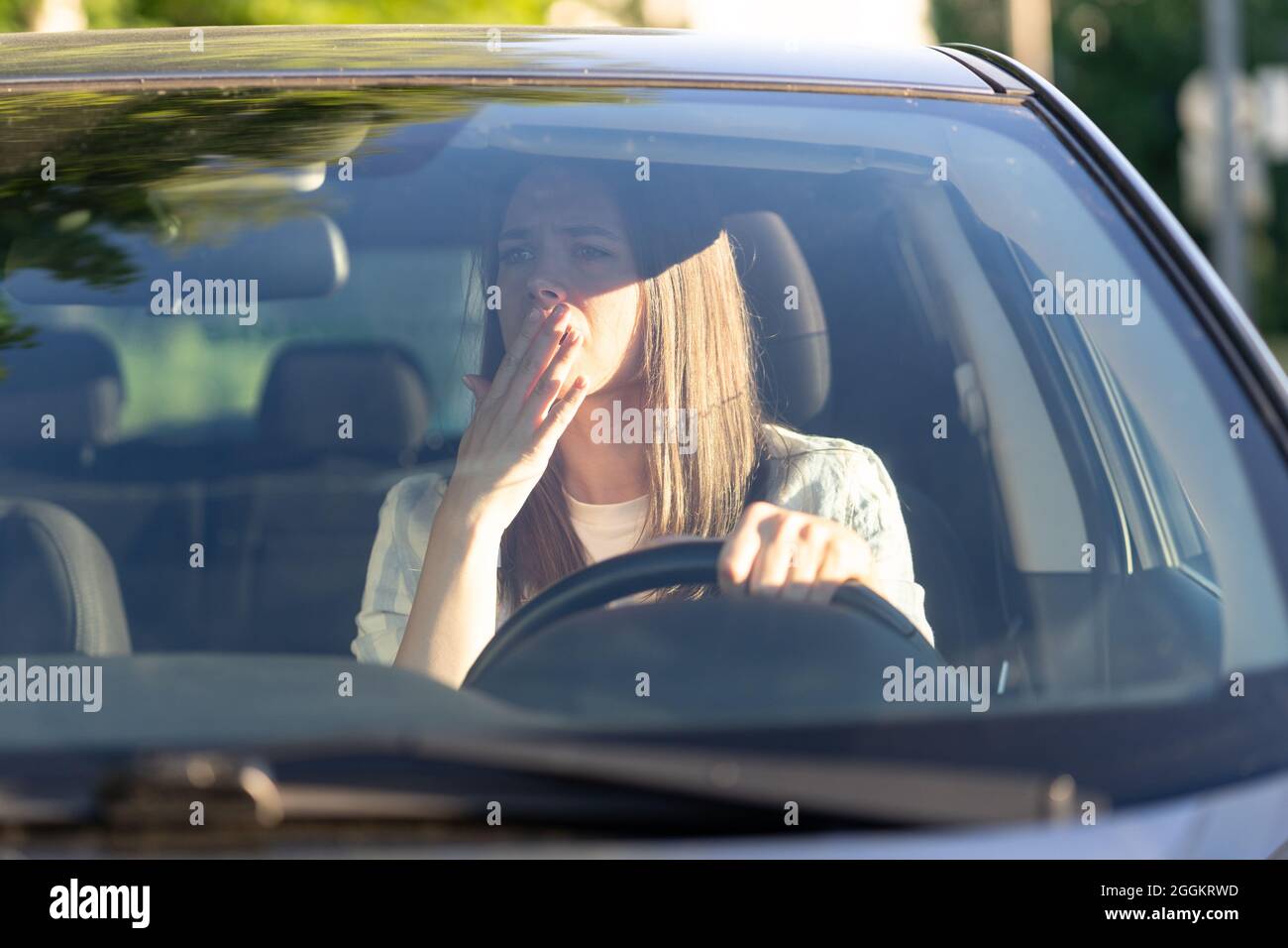Scared woman driver look in rear view mirror frightened of car accident ...