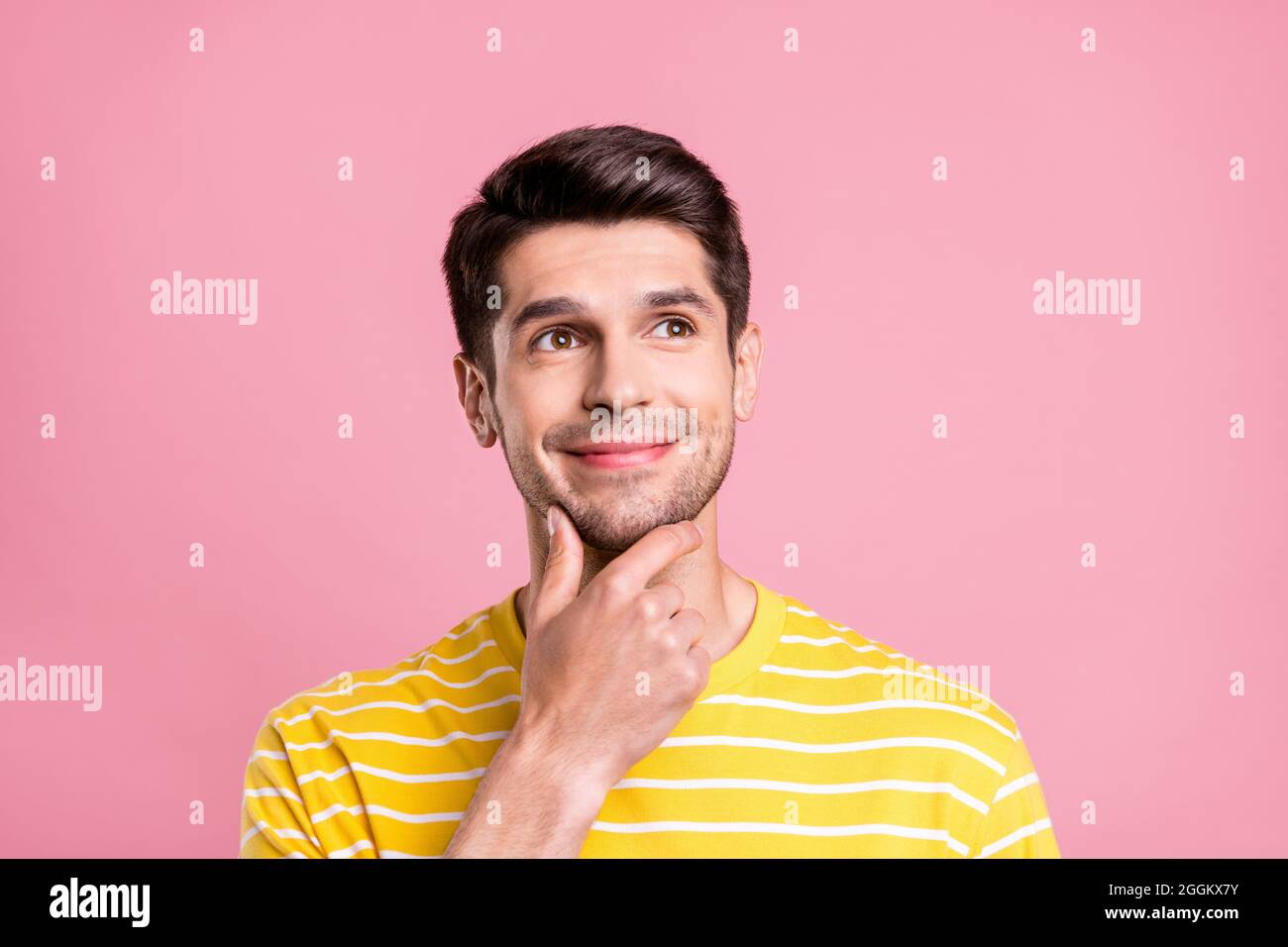 Portrait of attractive cheerful minded guy touching chin making ...