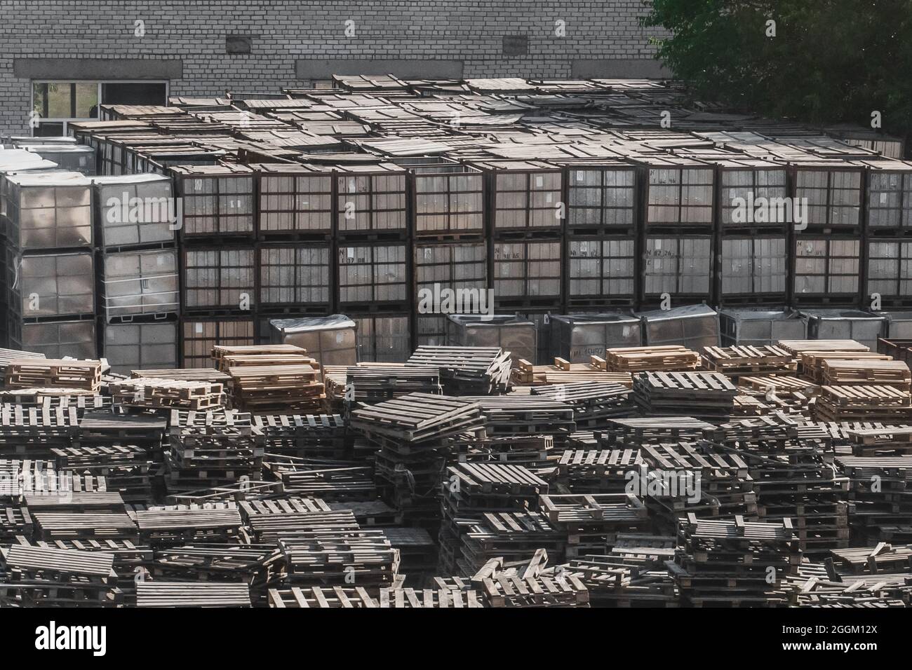 Storage of wooden pallets in an open warehouse. A bunch of industrial ...