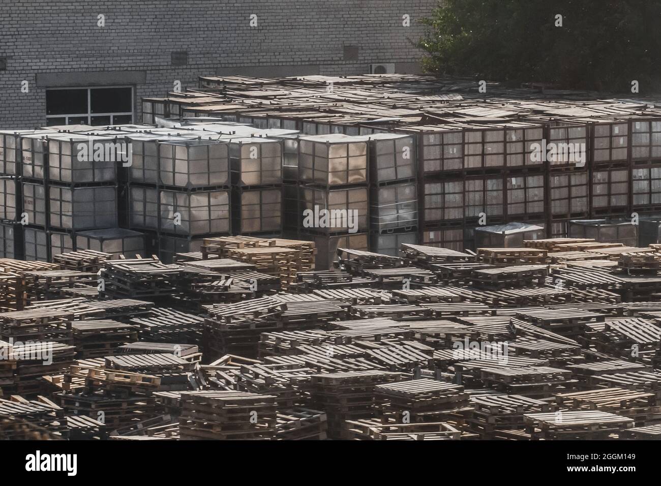 Storage of wooden pallets in an open warehouse. A bunch of industrial ...