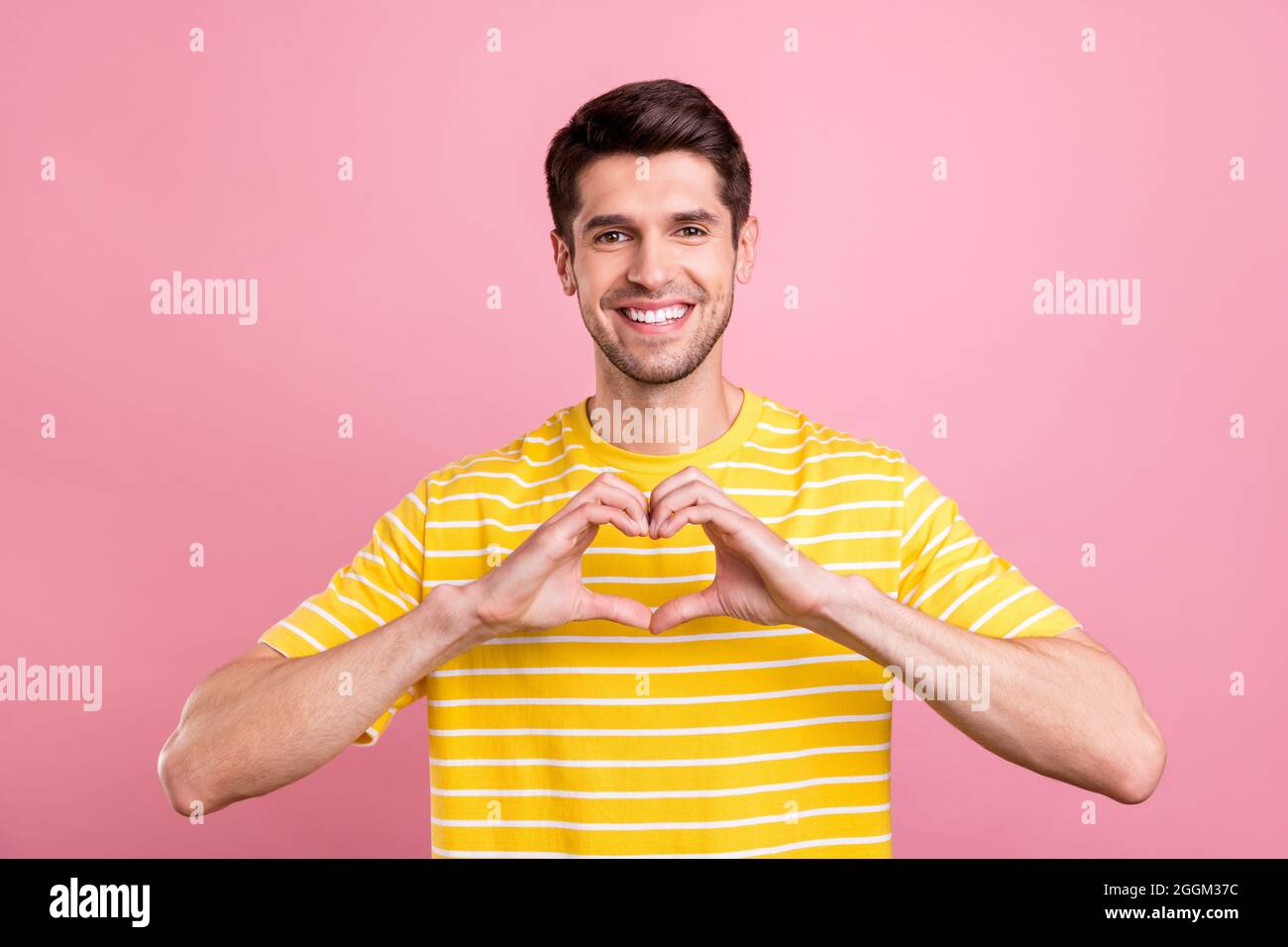 Photo of positive young happy man make fingers heart shape affection ...