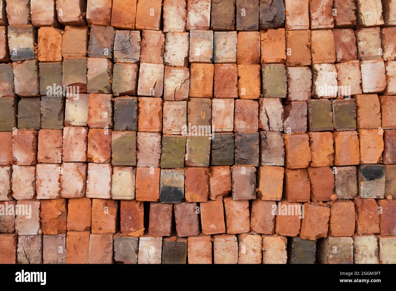 Texture of rows and columns of fired bricks, made by hand in a supply store in Sorong, West ...