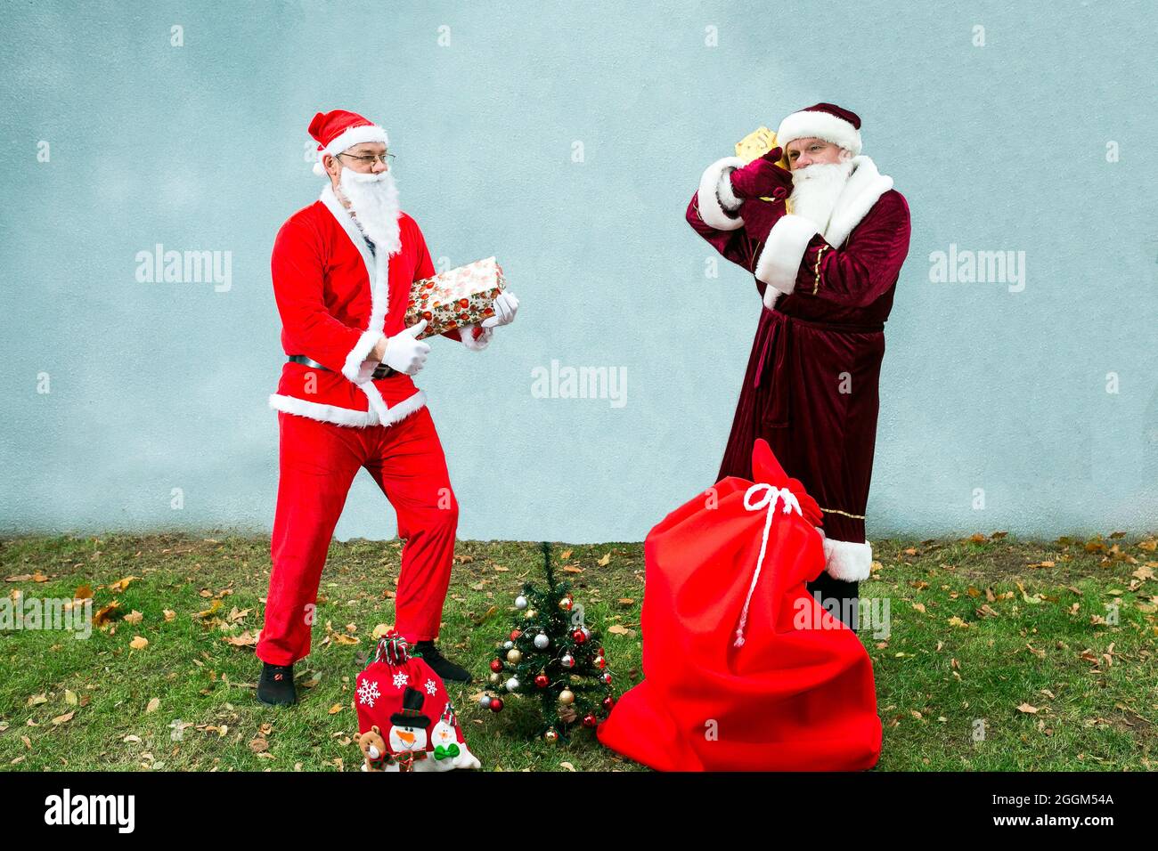 Two Santa Claus collect a big bag of gifts for Christmas. Close-up on a ...