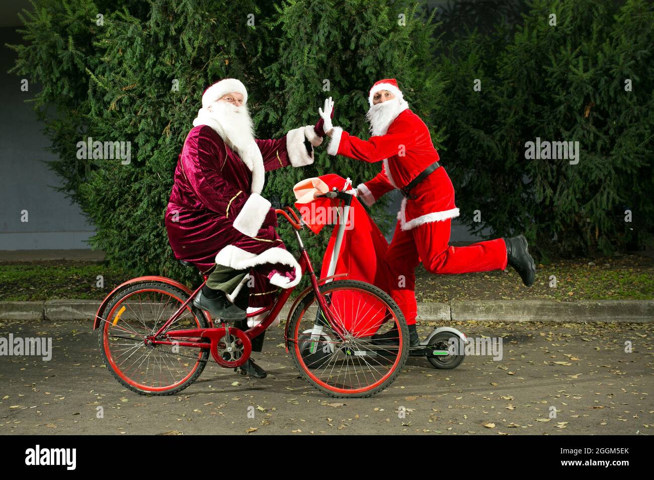 Meeting of two Santa Clauses. Santa Claus rides a scooter. Ded Moroz ...