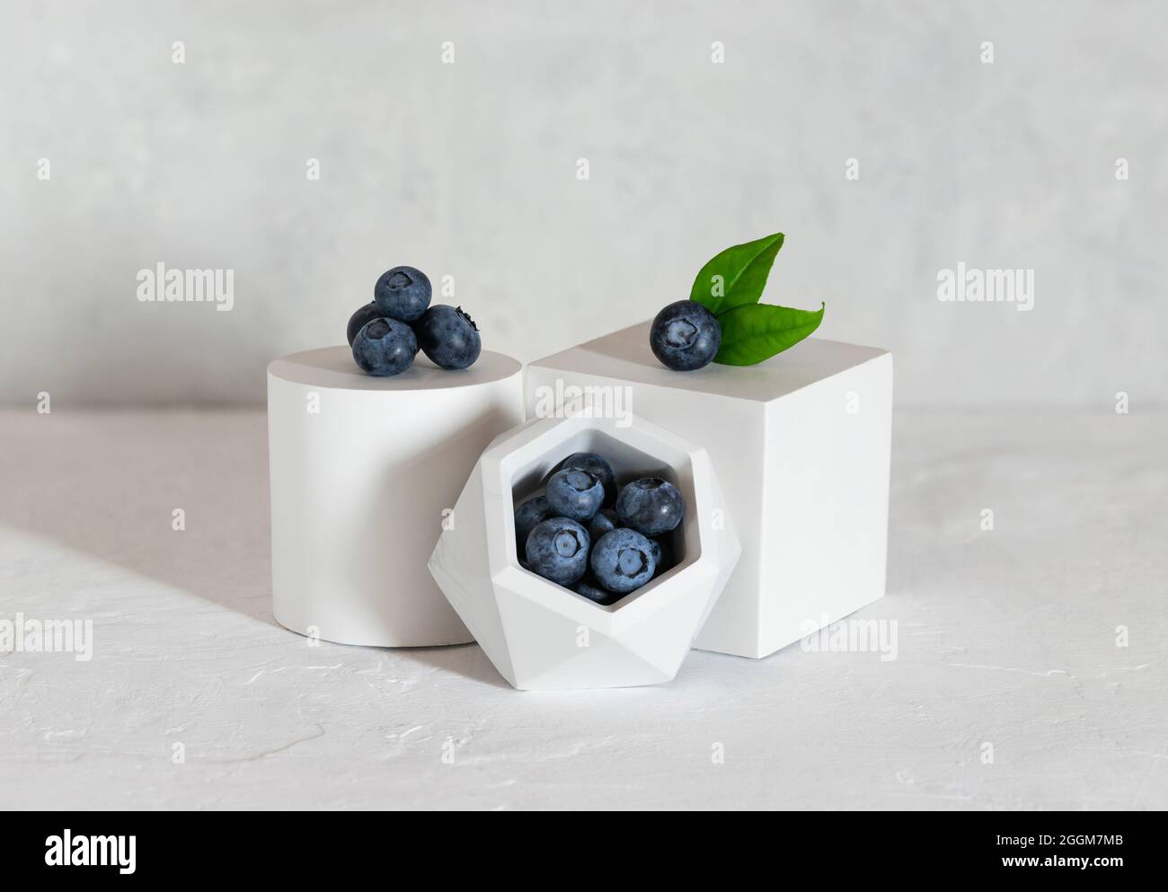 Blueberries on stand on a gray concrete background. Ripe fresh blue ...