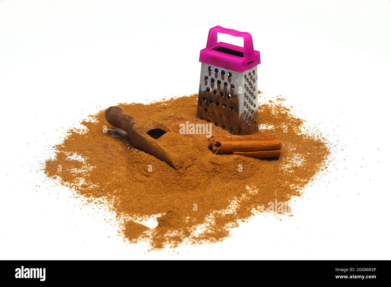Cinnamon sticks and grater on white background Stock Photo - Alamy