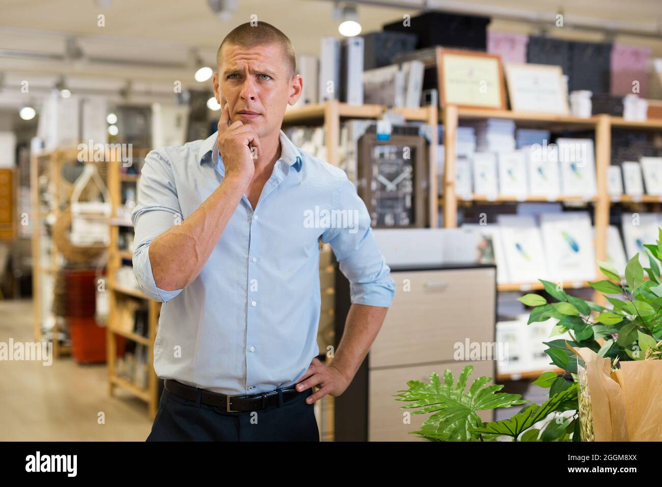 Man standing in store Stock Photo - Alamy