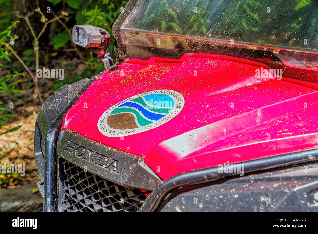 A ranger ATV parked along the Cedar Creek Trail at Natural Bridge State ...