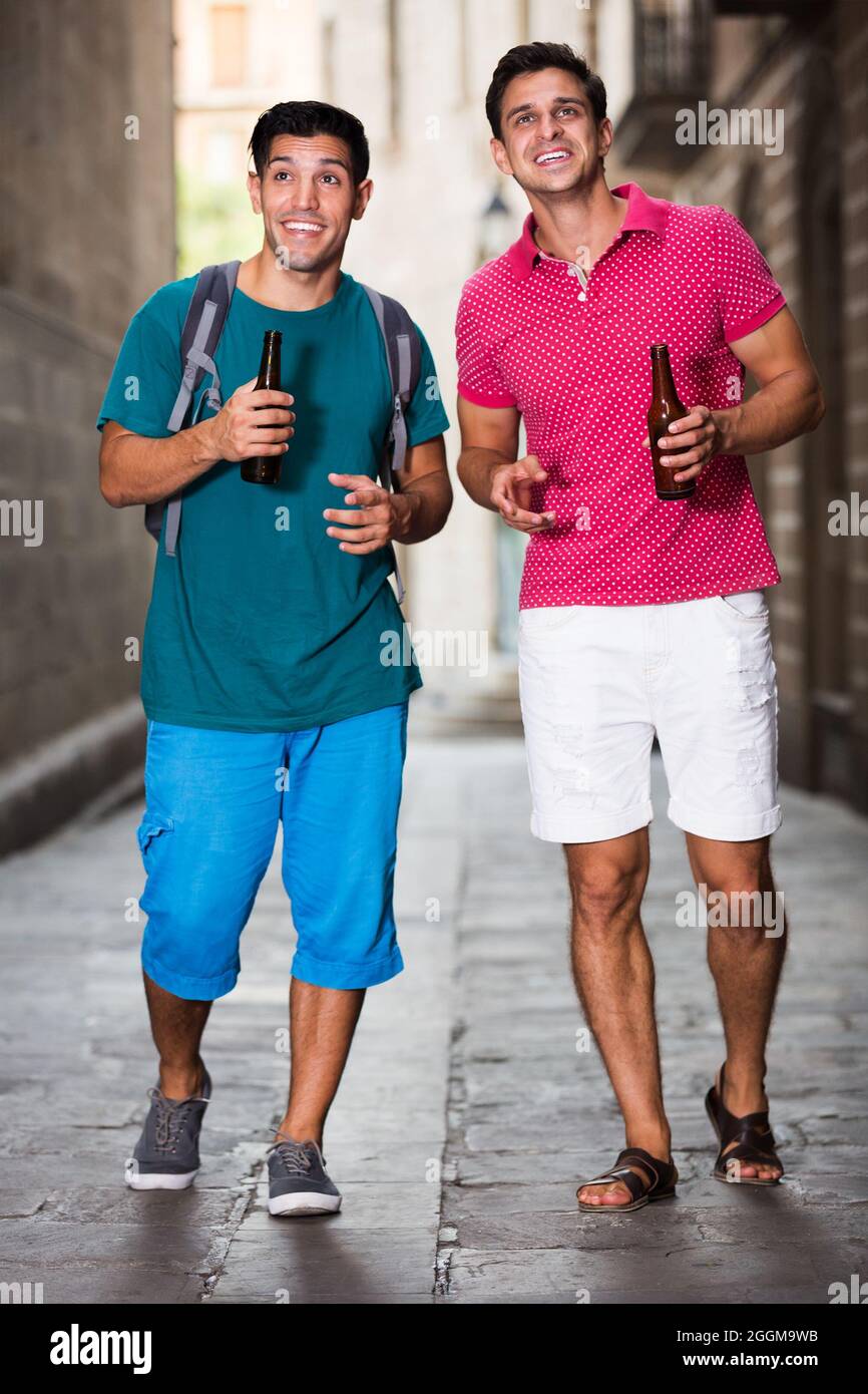 Male fans walking with beer Stock Photo - Alamy