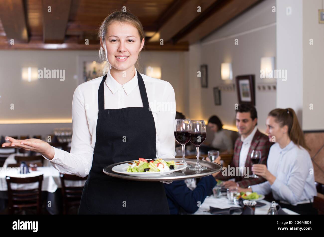 Waitress with serving tray Stock Photo - Alamy
