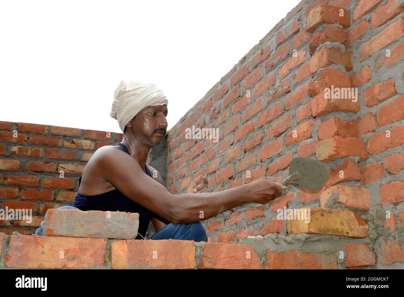 Manual Workers doing laborious job at a rural construction site in New ...