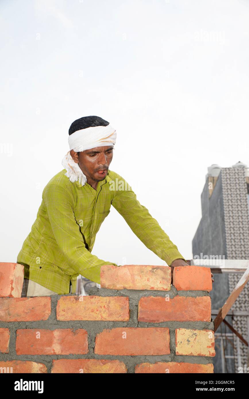 Manual Workers doing laborious job at a rural construction site in New ...