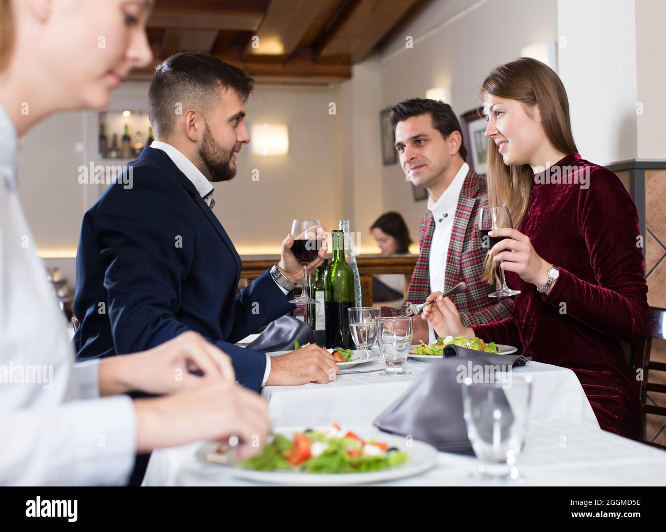 Friends having dinner at restaurant Stock Photo - Alamy