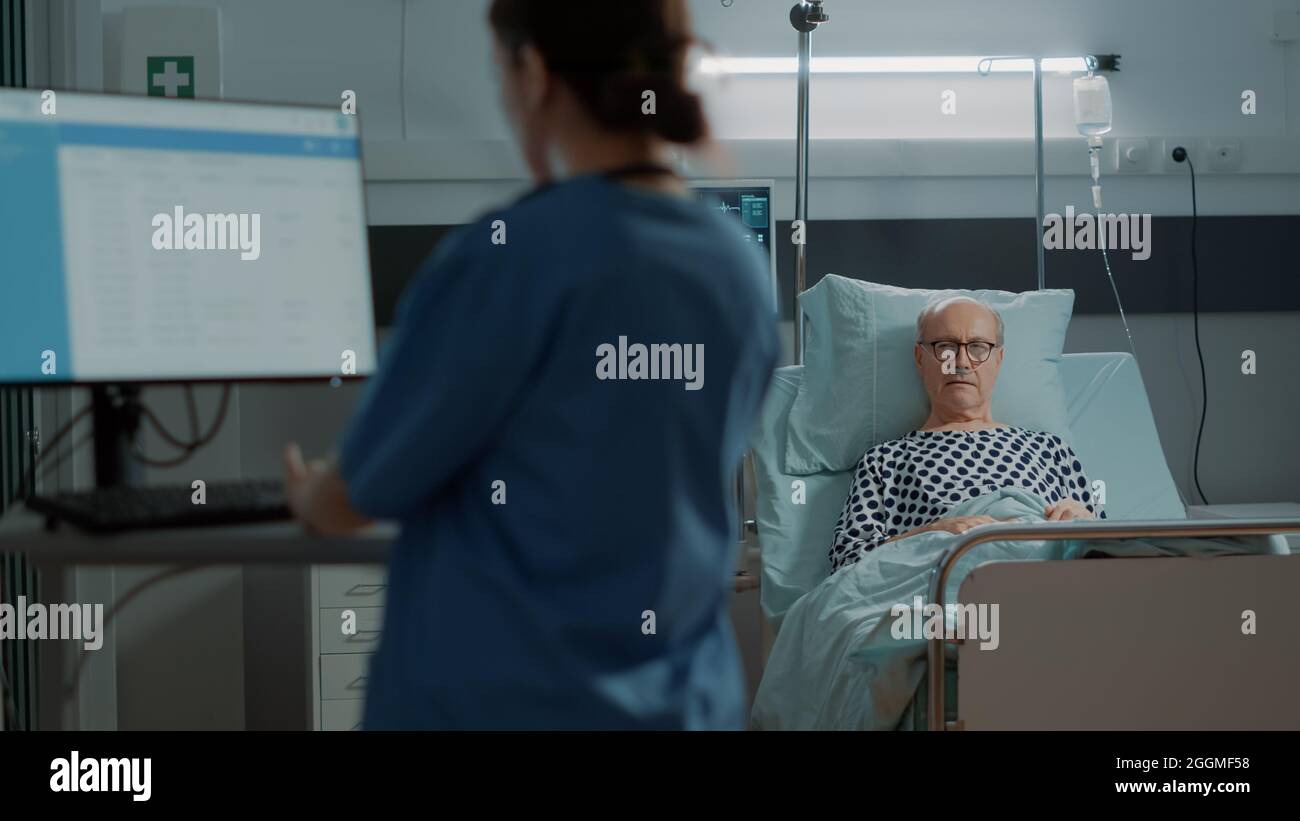 Elderly patient waiting for results in hospital ward bed at modern ...