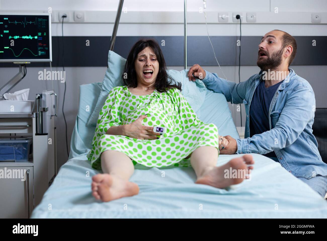 Woman with pregnancy having painful contractions getting into labor and ...