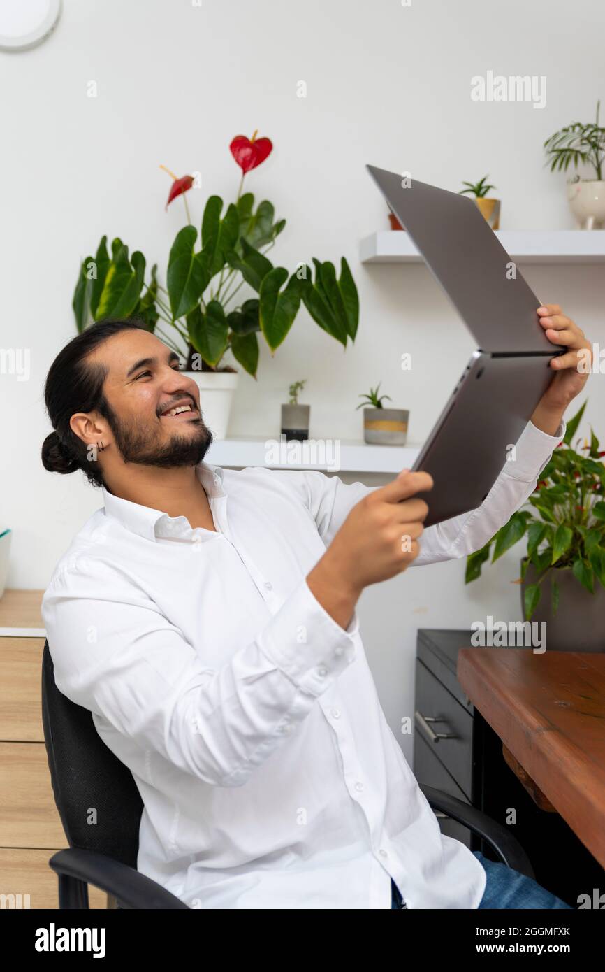 Cheerful young man working home hi-res stock photography and images - Alamy