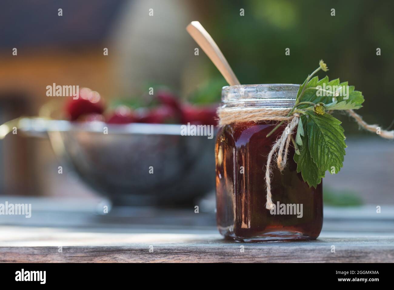 Strawberry jam in a jar on a wooden board. Fermented berries Stock ...