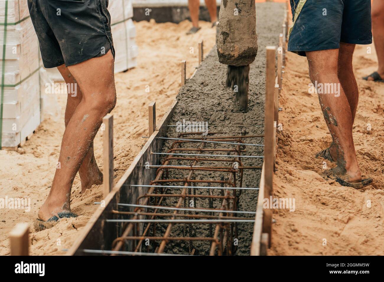 Construction of building foundation. Pouring with liquid concrete of ...