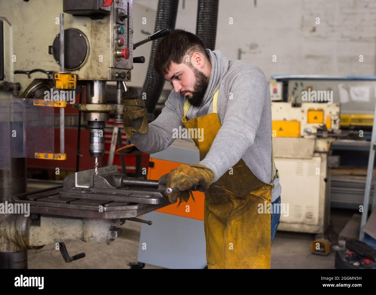 Young man using drill machine hi-res stock photography and images - Alamy