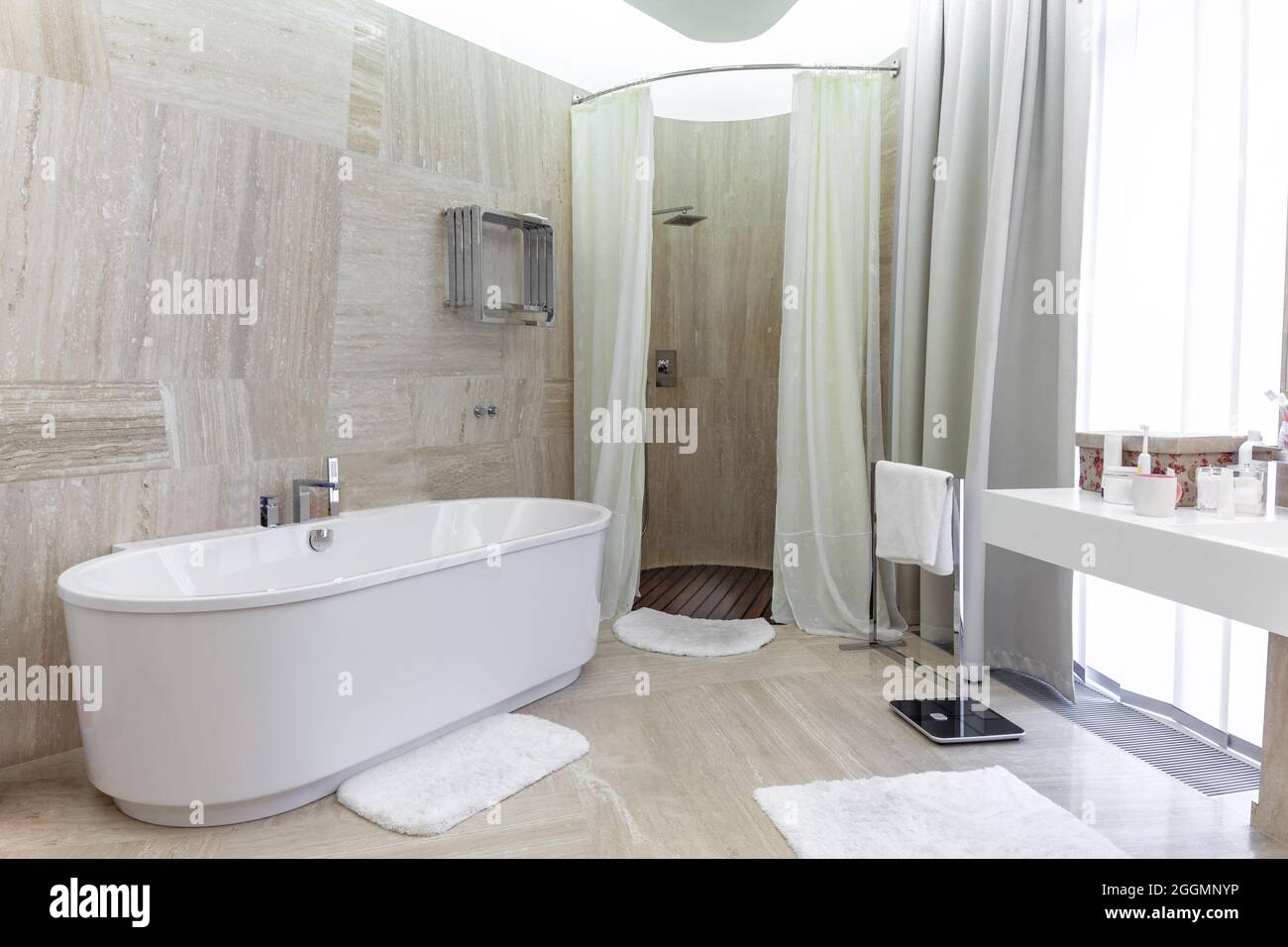 Functional bathroom with walk-in shower, bathtub, comfortable furniture ...