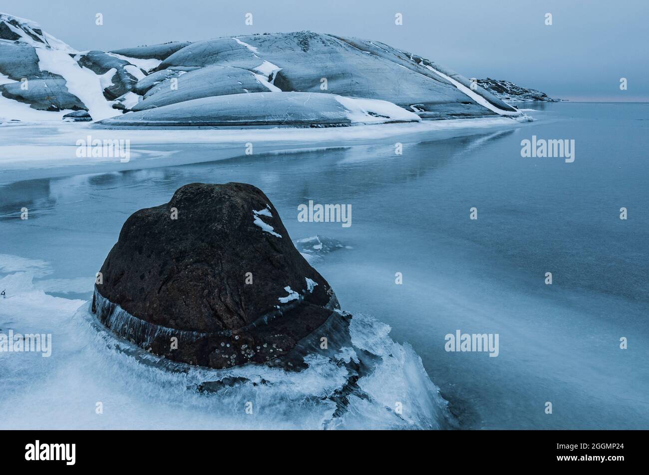 Stone at frozen coastline, Sweden Stock Photo - Alamy