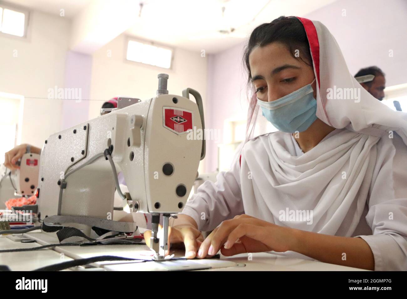 QUETTA-PAKISTAN. August 31-2021. A female student is busy in dress ...