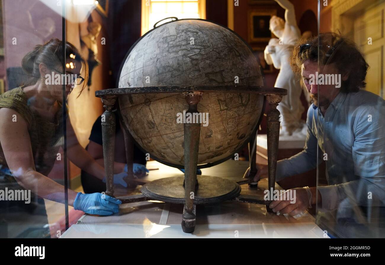 National Trust conservators move a rare Elizabethan globe into it's new ...