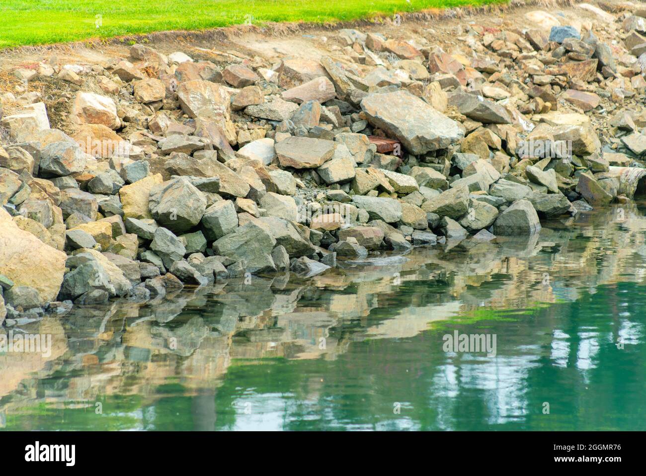 Natural view of piled rocks on the riverside Stock Photo - Alamy