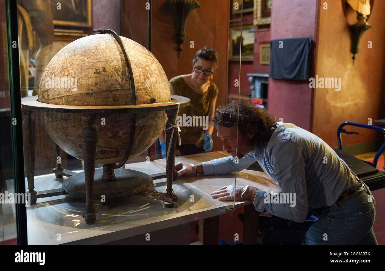 National Trust conservators move a rare Elizabethan globe into it's new ...