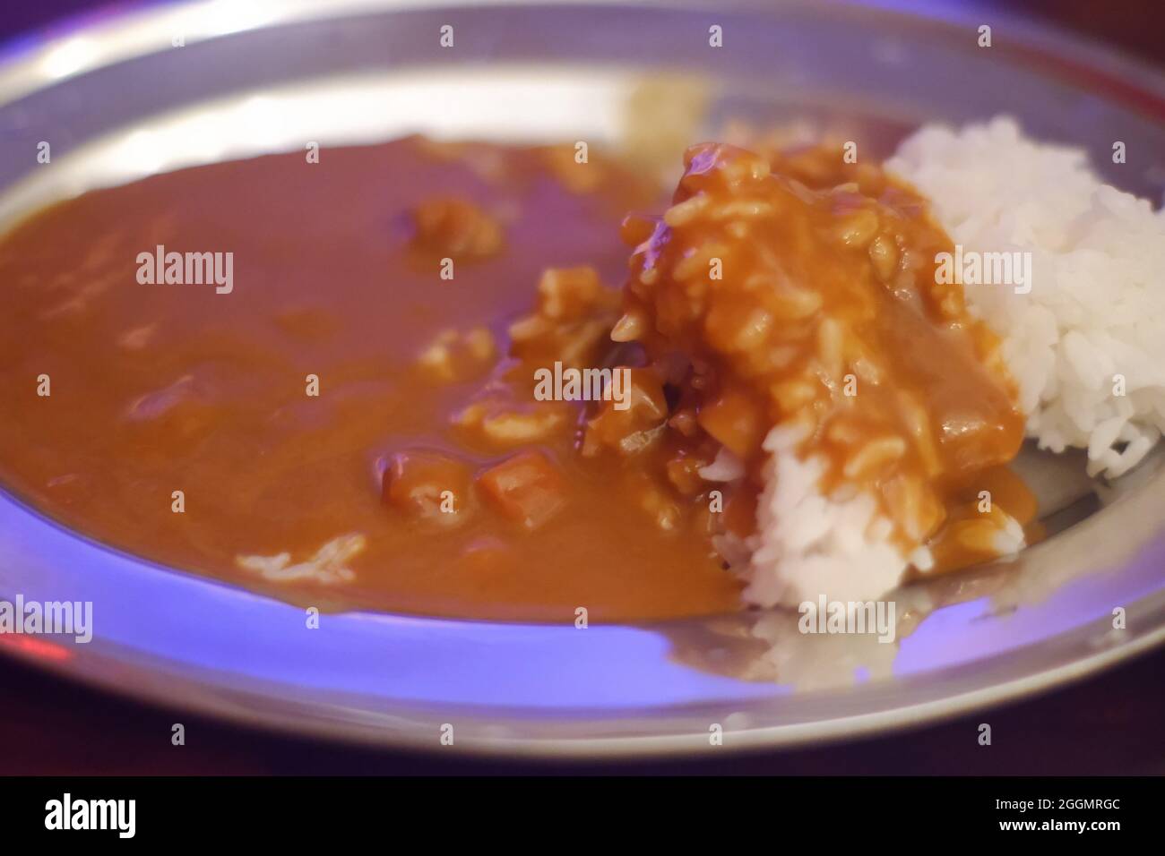 Curry and rice served in a stainless steel oval plate Stock Photo - Alamy